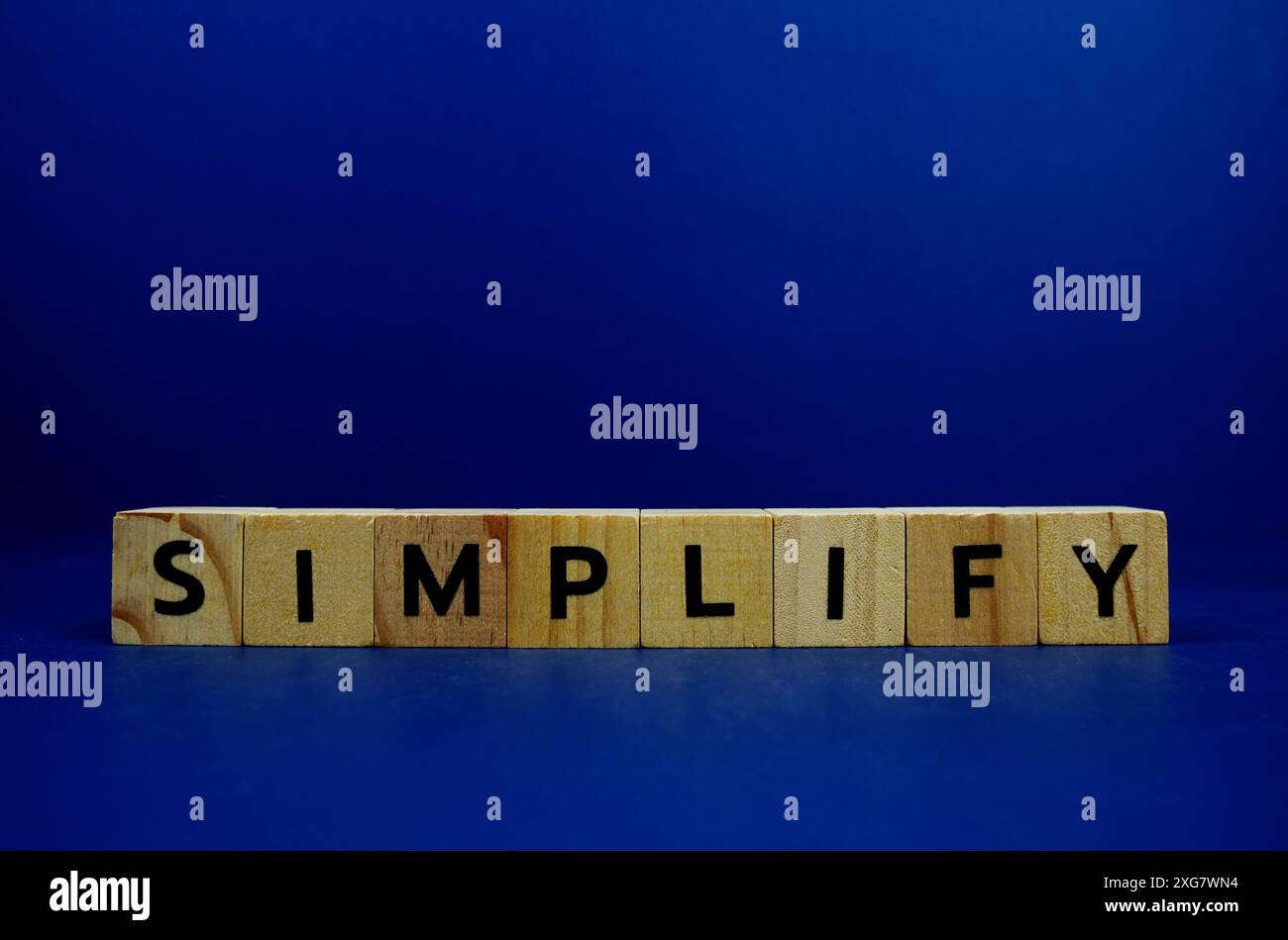 Simplify with wooden blocks alphabet letters and Magnifying glass on ...