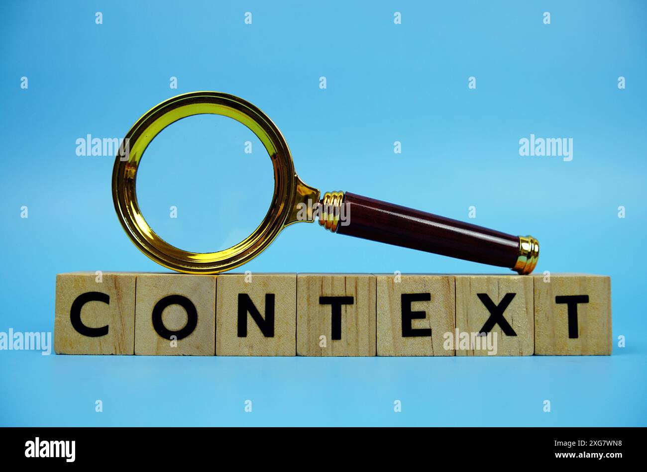 Context with wooden blocks alphabet letters and Magnifying glass on ...