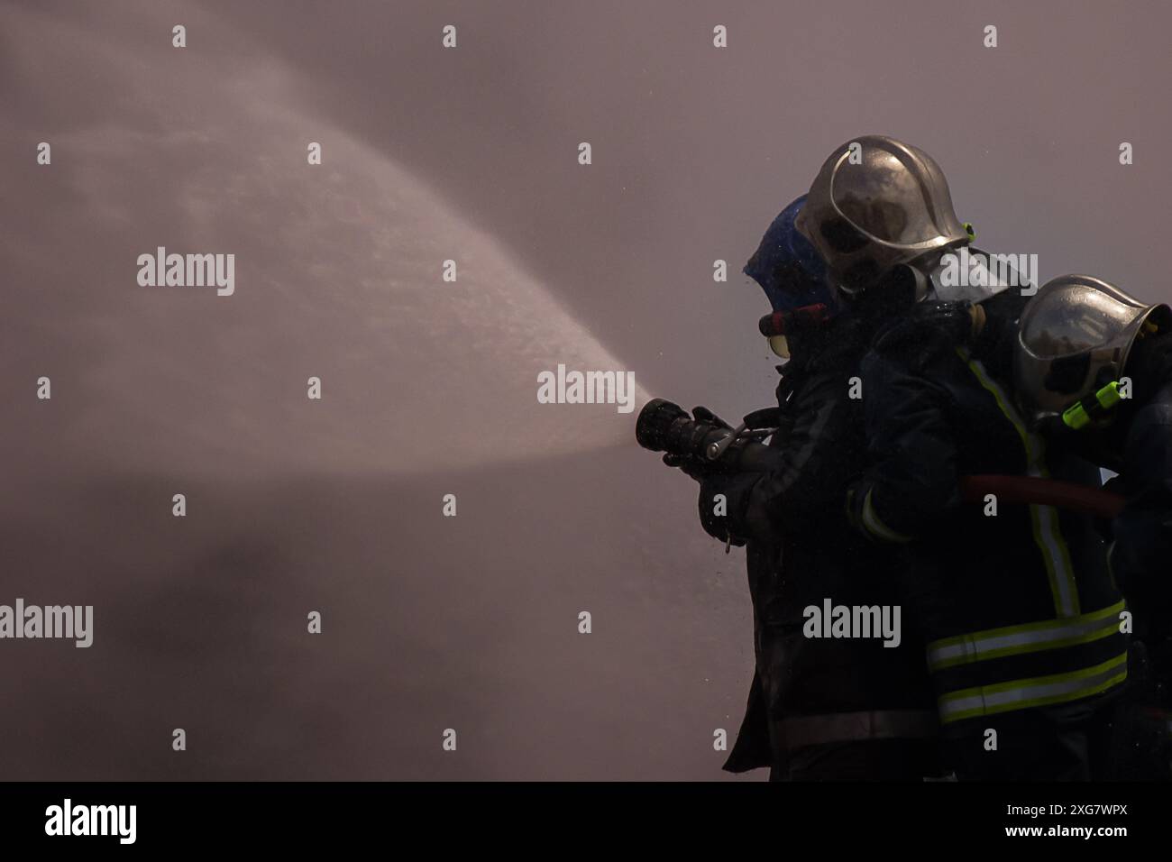 firefighters in action Stock Photo - Alamy