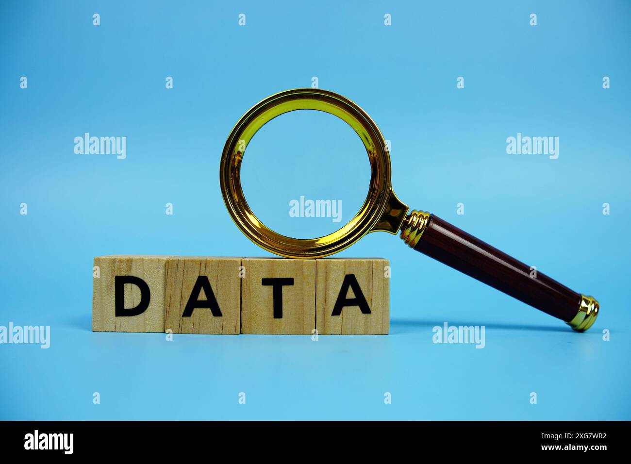 Data with wooden blocks alphabet letters and Magnifying glass on blue ...