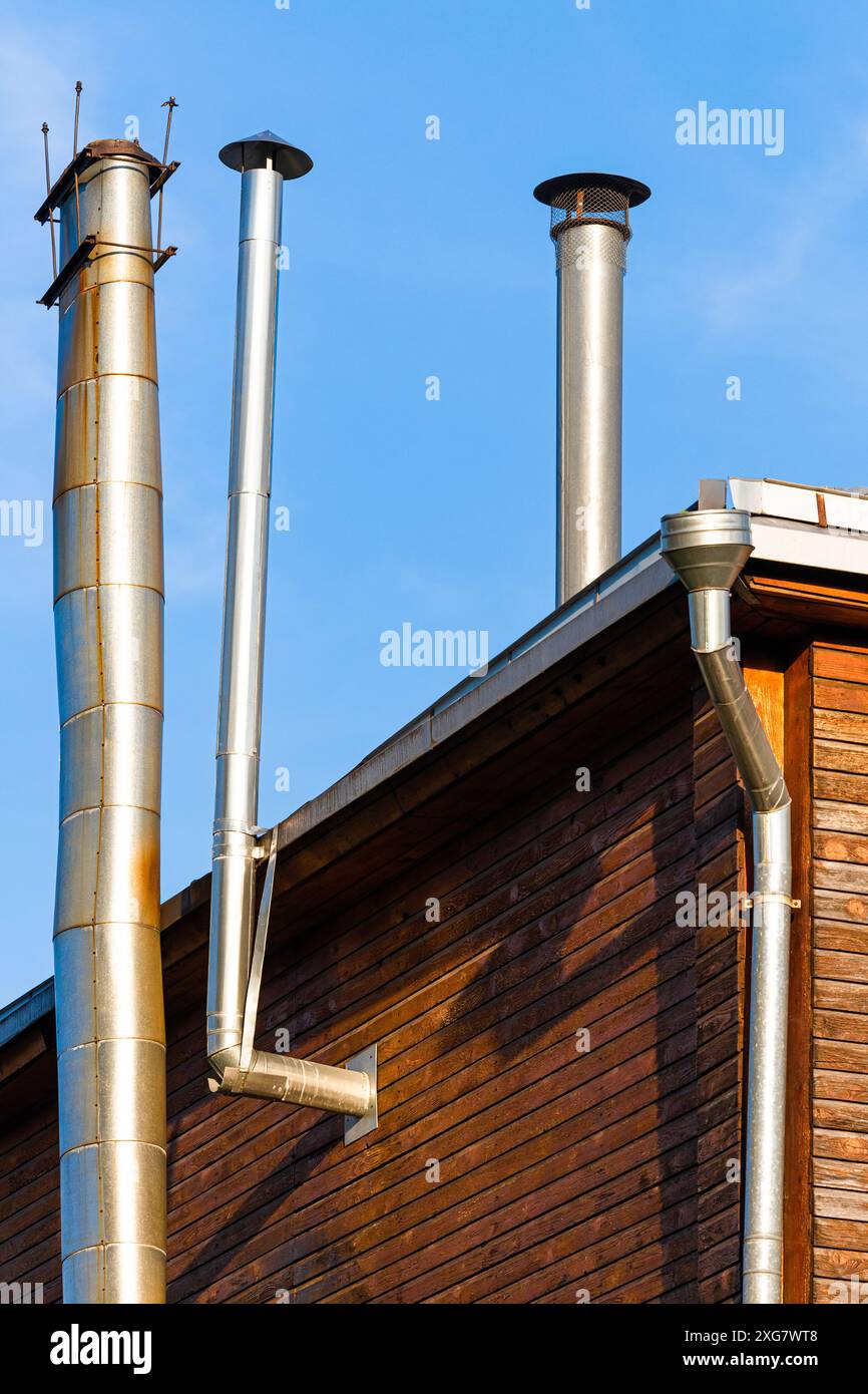 house with stainless steel chimney pipes, vertical photo. pipe for ...
