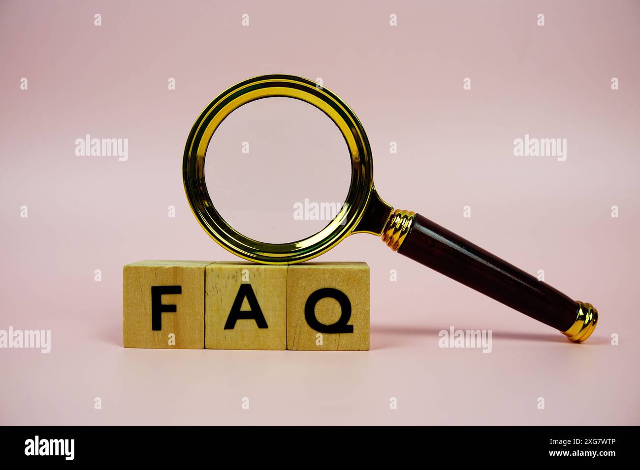 FAQ with wooden blocks alphabet letters and Magnifying glass on pink ...
