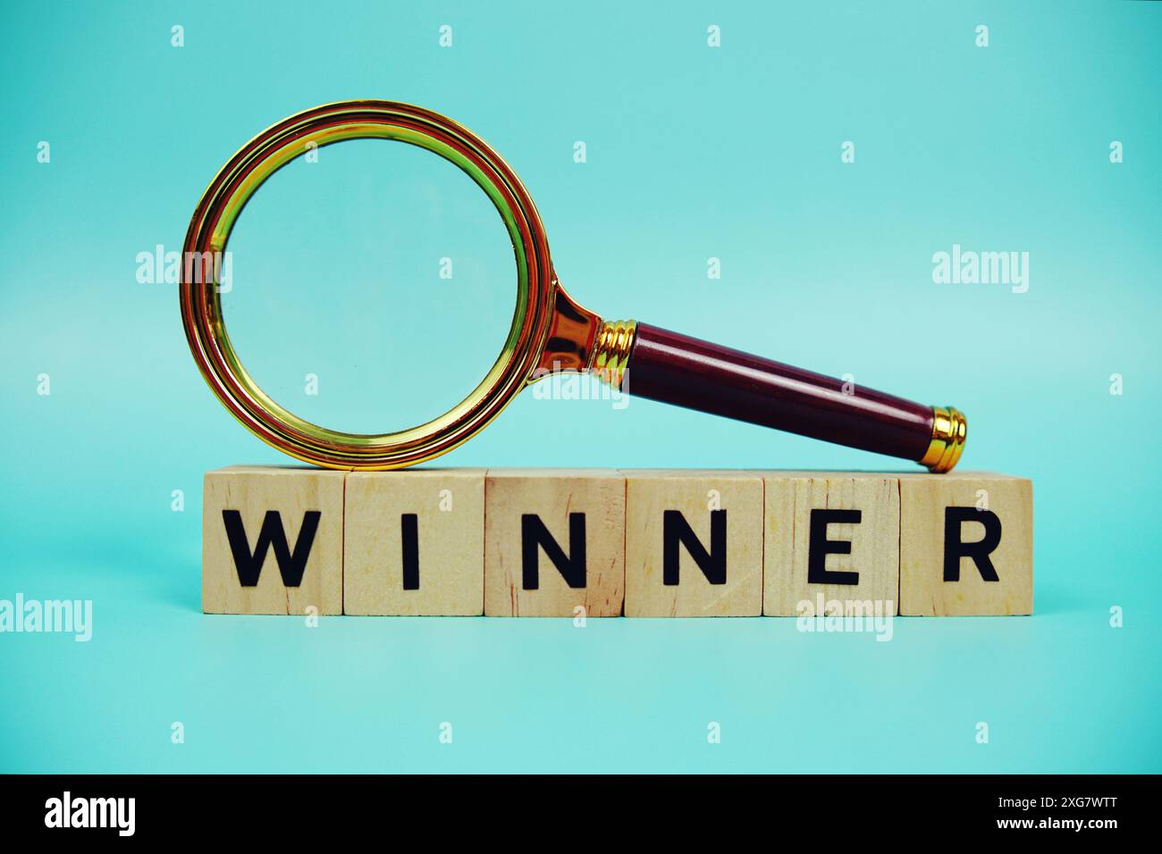 Winner with wooden blocks alphabet letters and Magnifying glass on blue ...