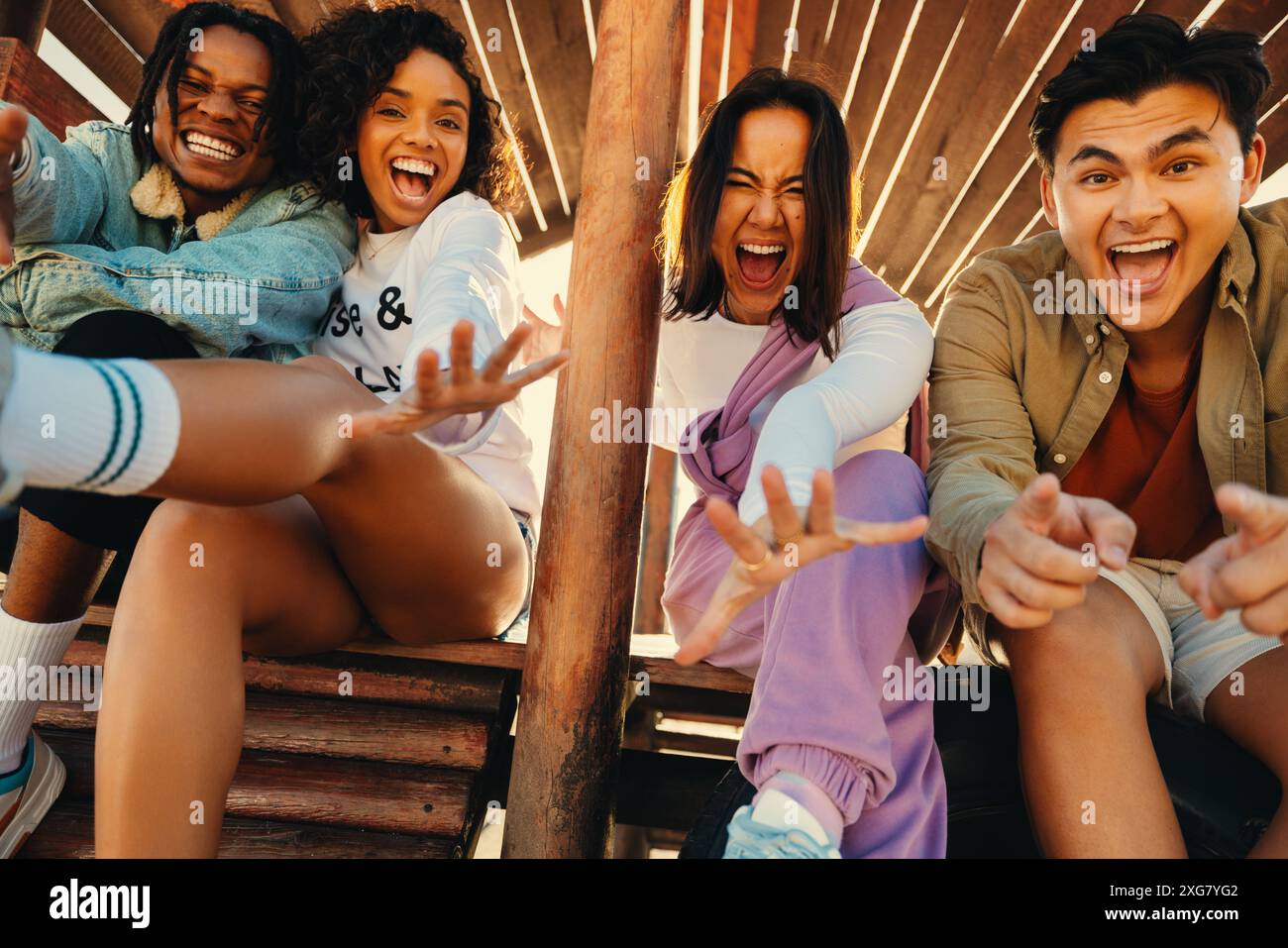 Group of four joyful friends having fun and laughing together outside ...