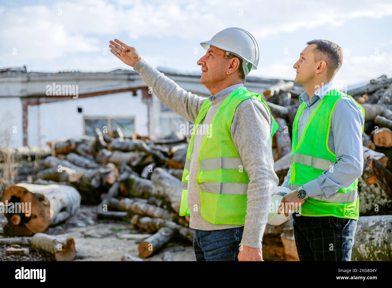 Construction workers discussing project in hi-res stock photography and ...