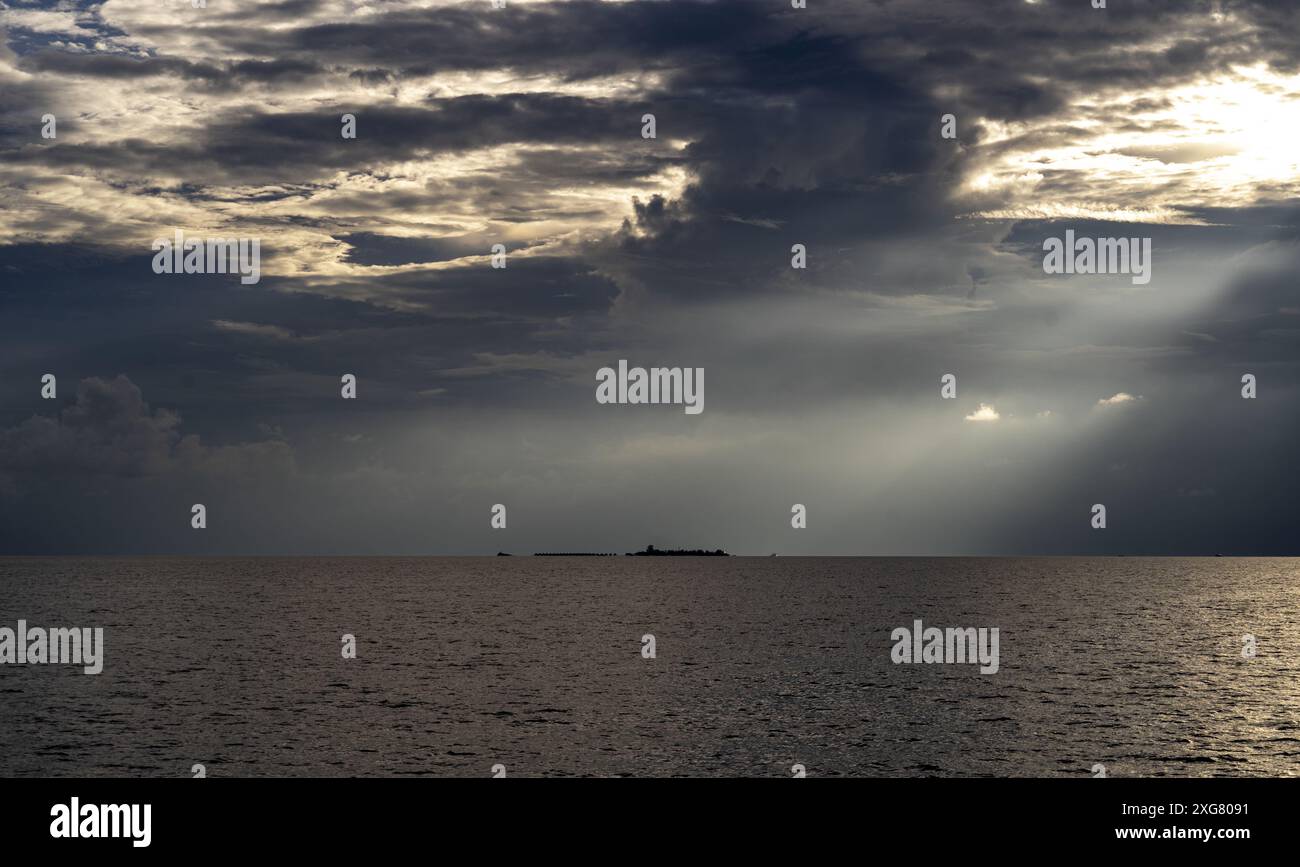 Sun rays filtering through the clouds on the Indian Ocean Stock Photo ...