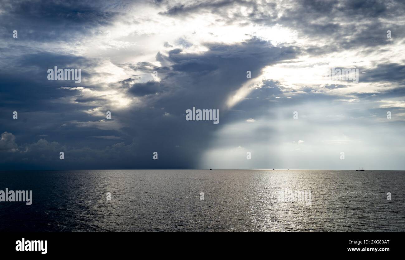 Sun rays filtering through the clouds on the Indian Ocean Stock Photo ...