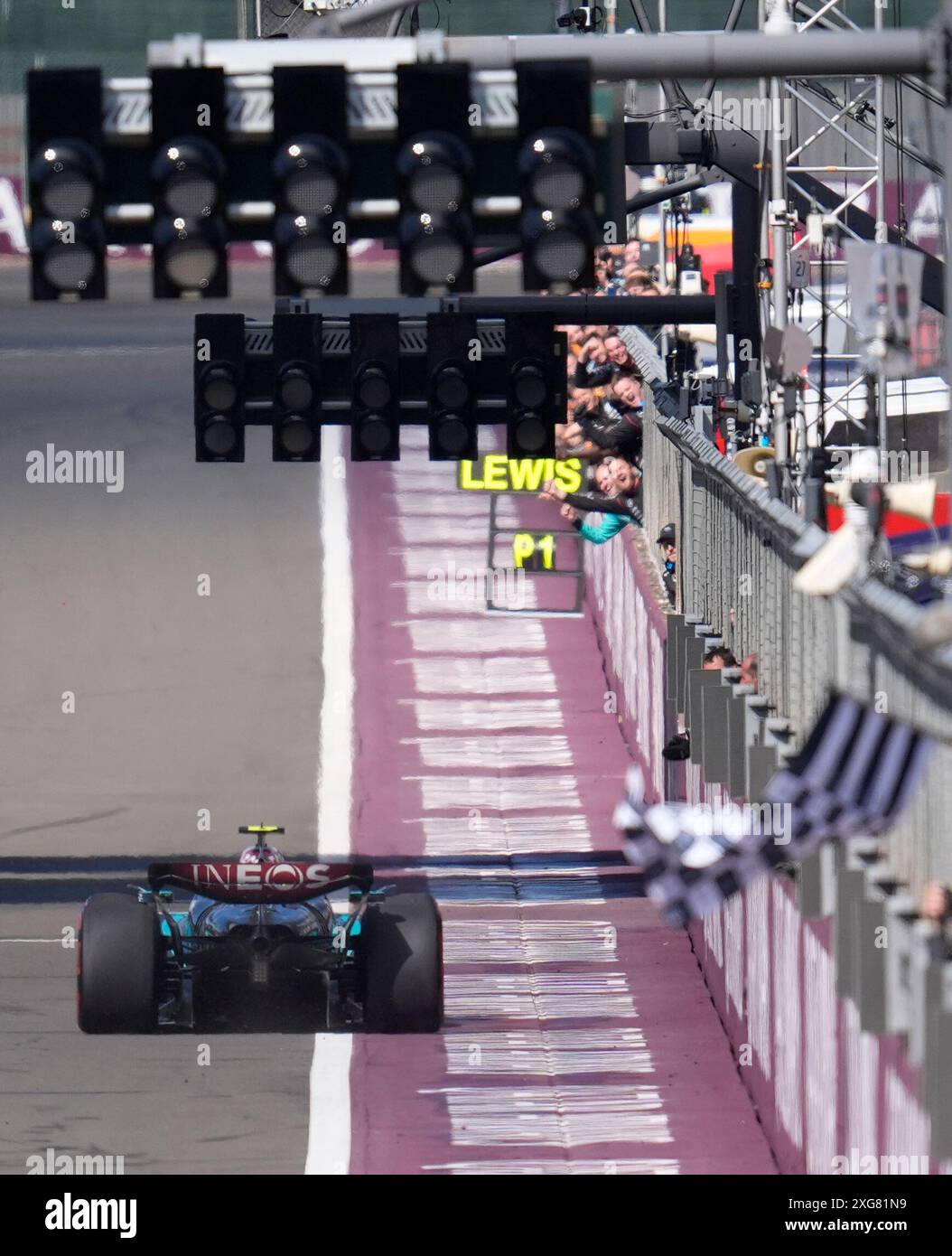 Mercedes driver Lewis Hamilton crosses the finish line to win the ...