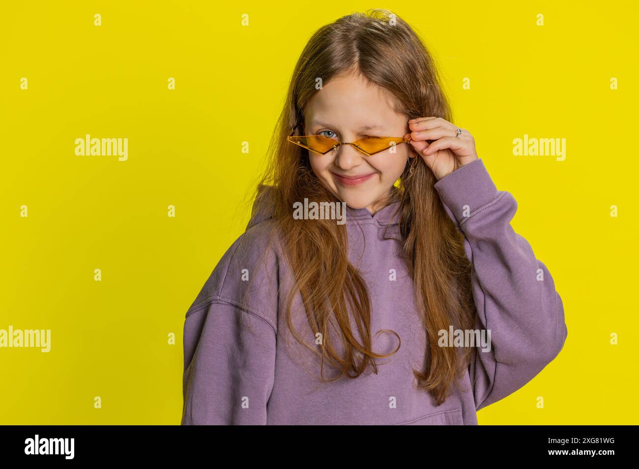 Portrait of playful happy preteen child girl kid wearing orange ...