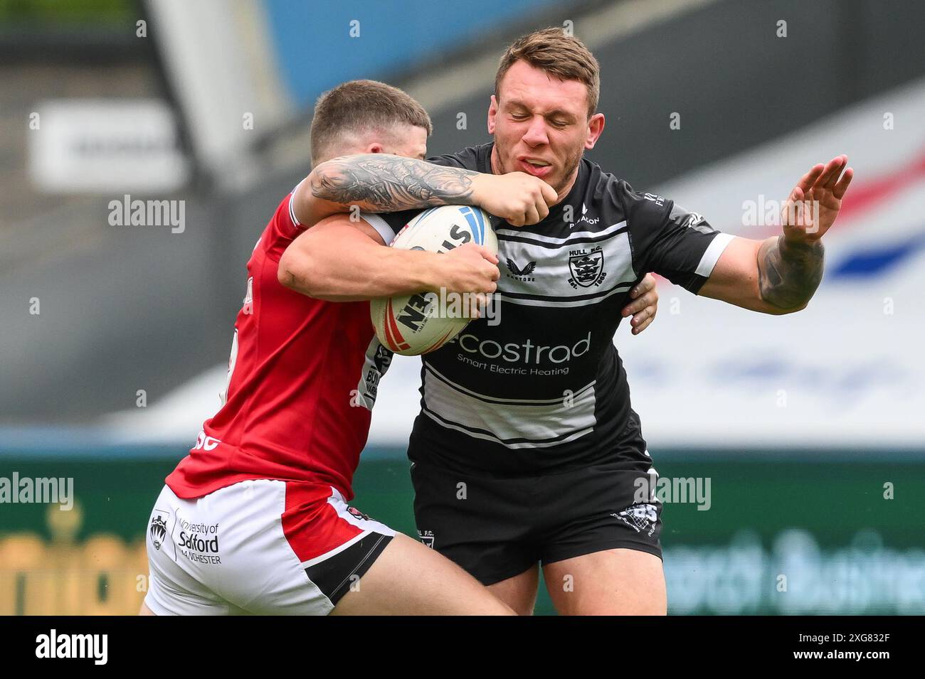 Jordan Lane Hull FC is tackled by Amir Bourouh of Salford Red Devils ...
