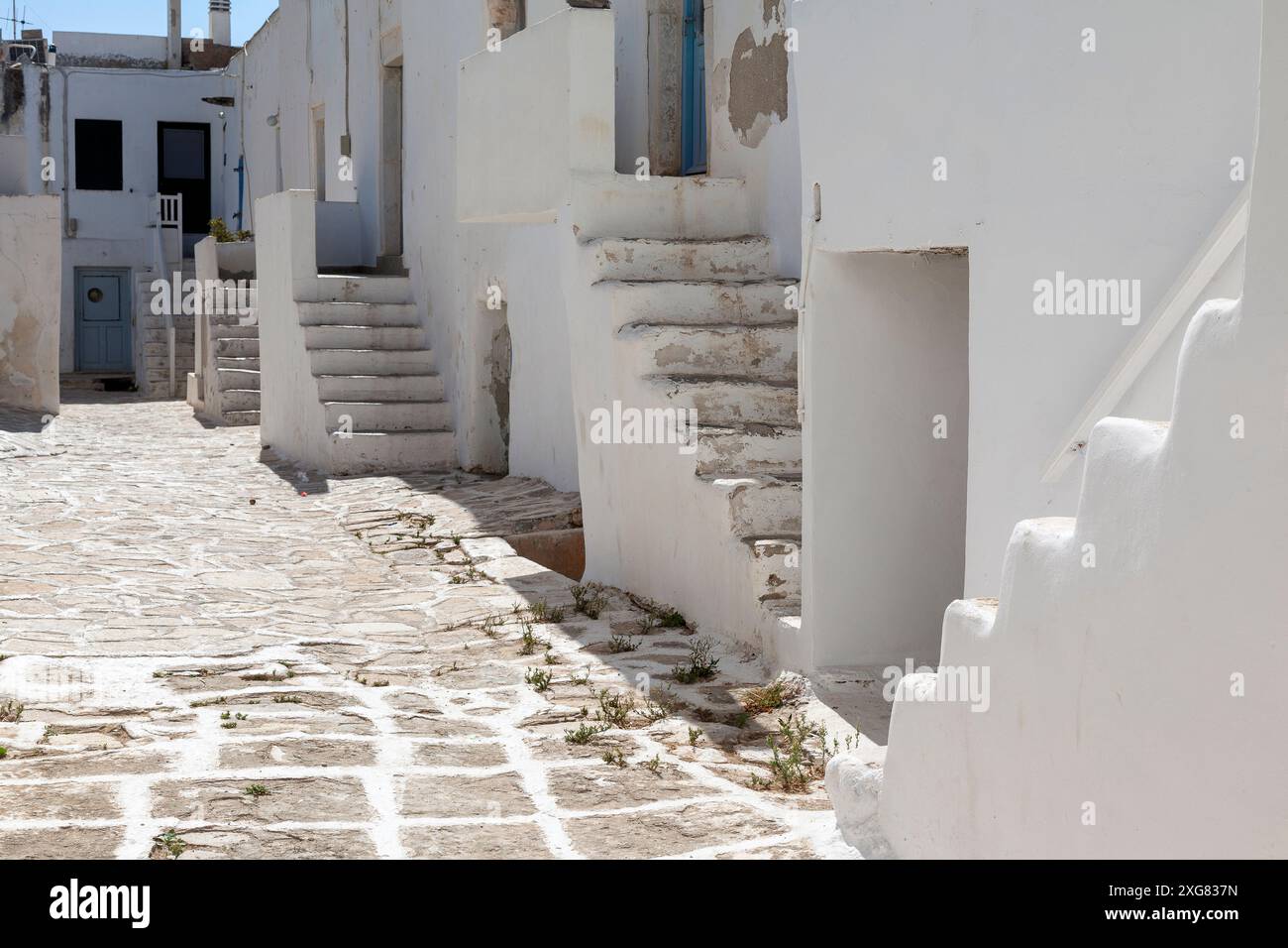 A quiet street in Antiparos, Greece, featuring traditional whitewashed ...