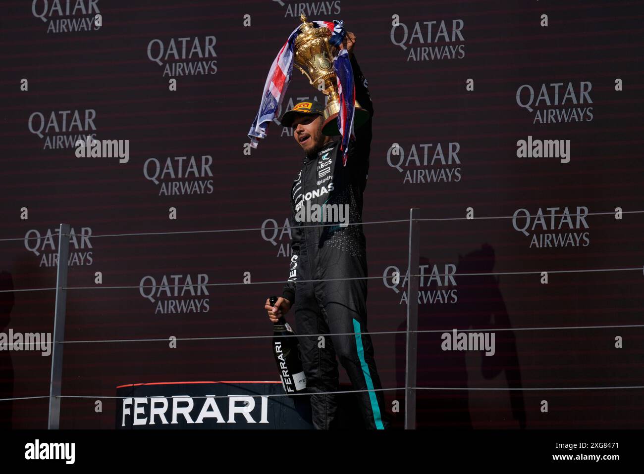 Mercedes driver Lewis Hamilton lifts the British Grand Prix Trophy as ...