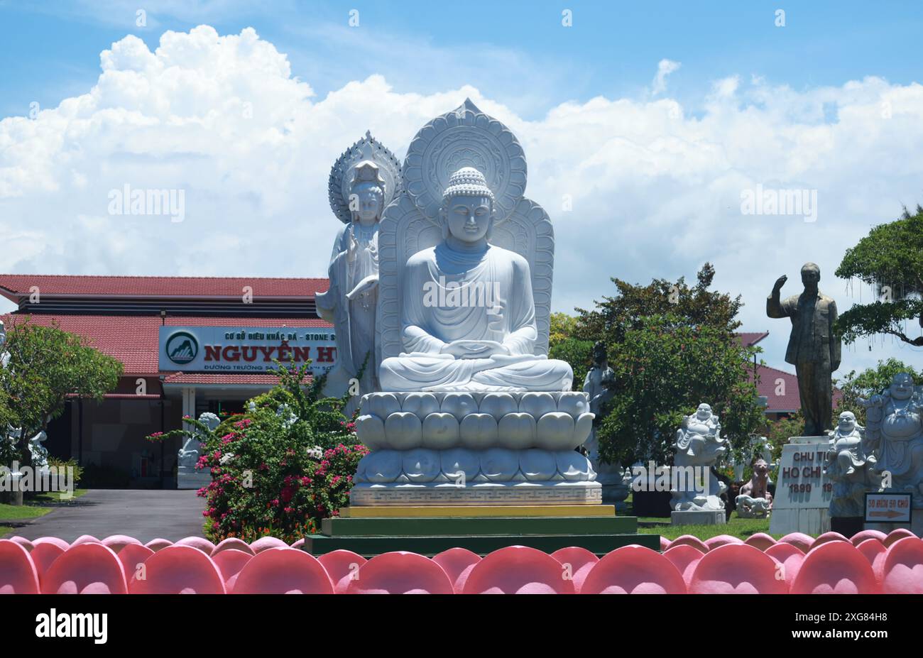 white marble buddha statue is displayed outside the stone sculpture ...