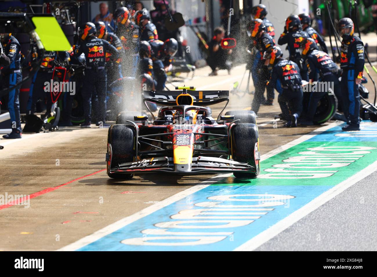 Red Bull driver Sergio Perez of Mexico steers his car after a pit service during the British ...