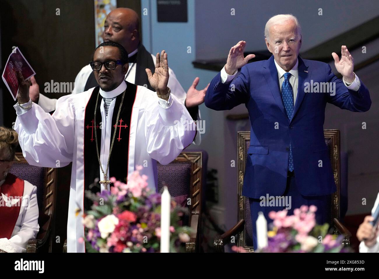 President Joe Biden, right, and pastor Dr. J. Louis Felton pray at a ...