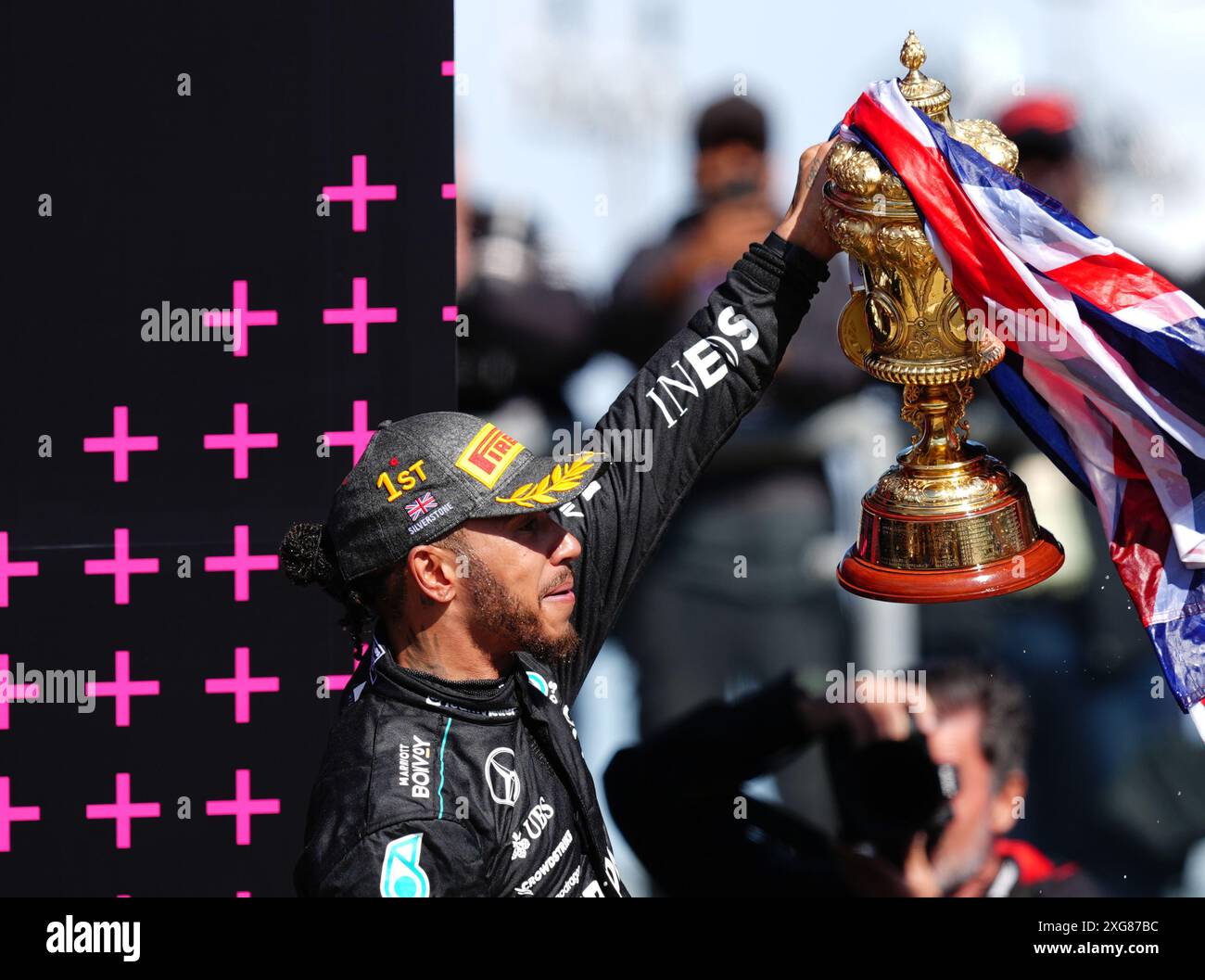 Mercedes' Lewis Hamilton celebtraing with the trophy on the podium at ...