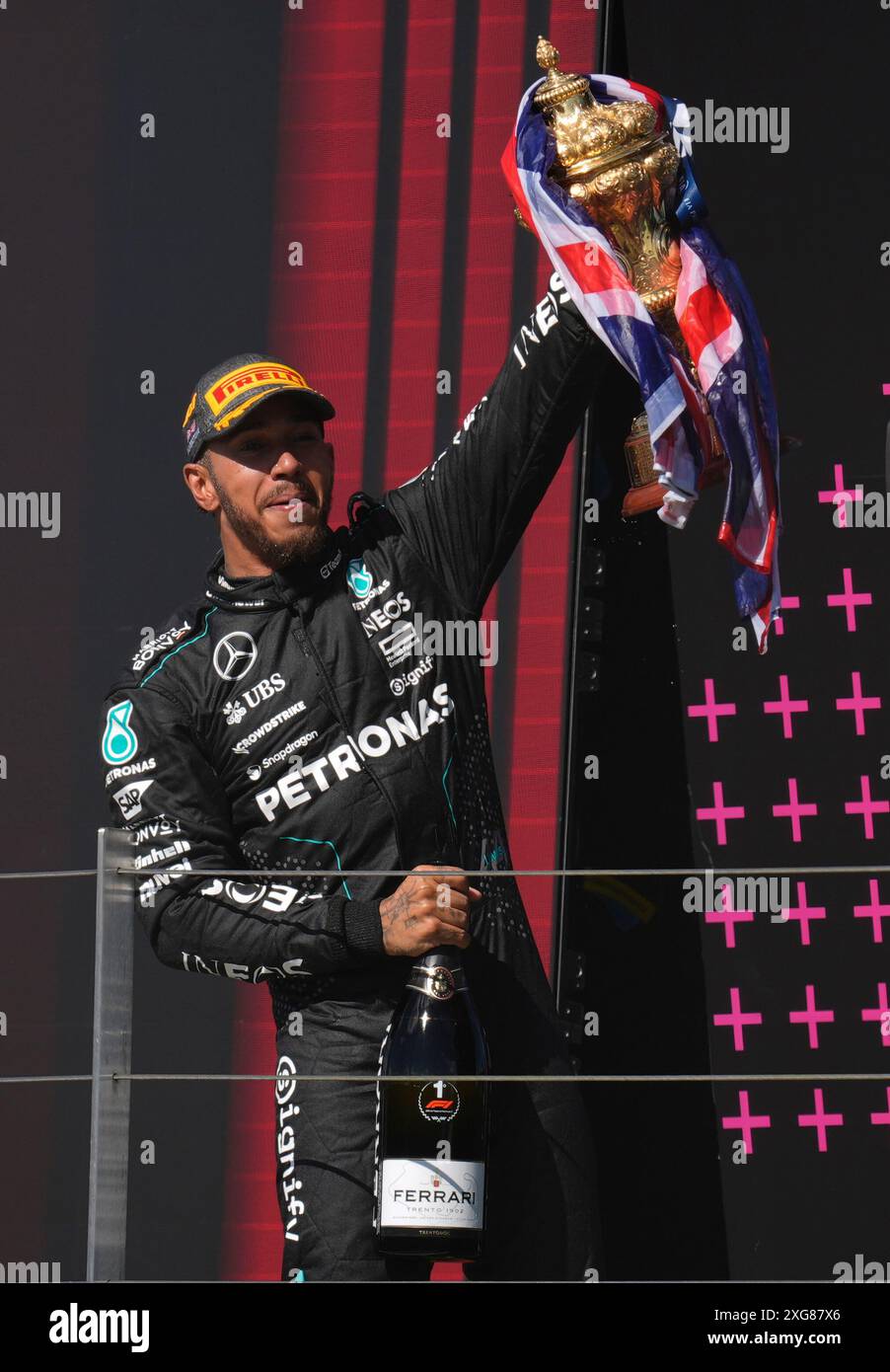 Mercedes driver Lewis Hamilton lifts the British Grand Prix Trophy as ...