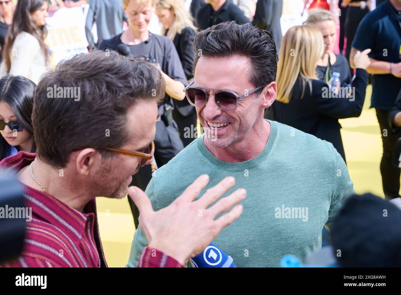 07 July 2024, Berlin: Actors Ryan Reynolds (l) and Hugh Jackman arrive ...
