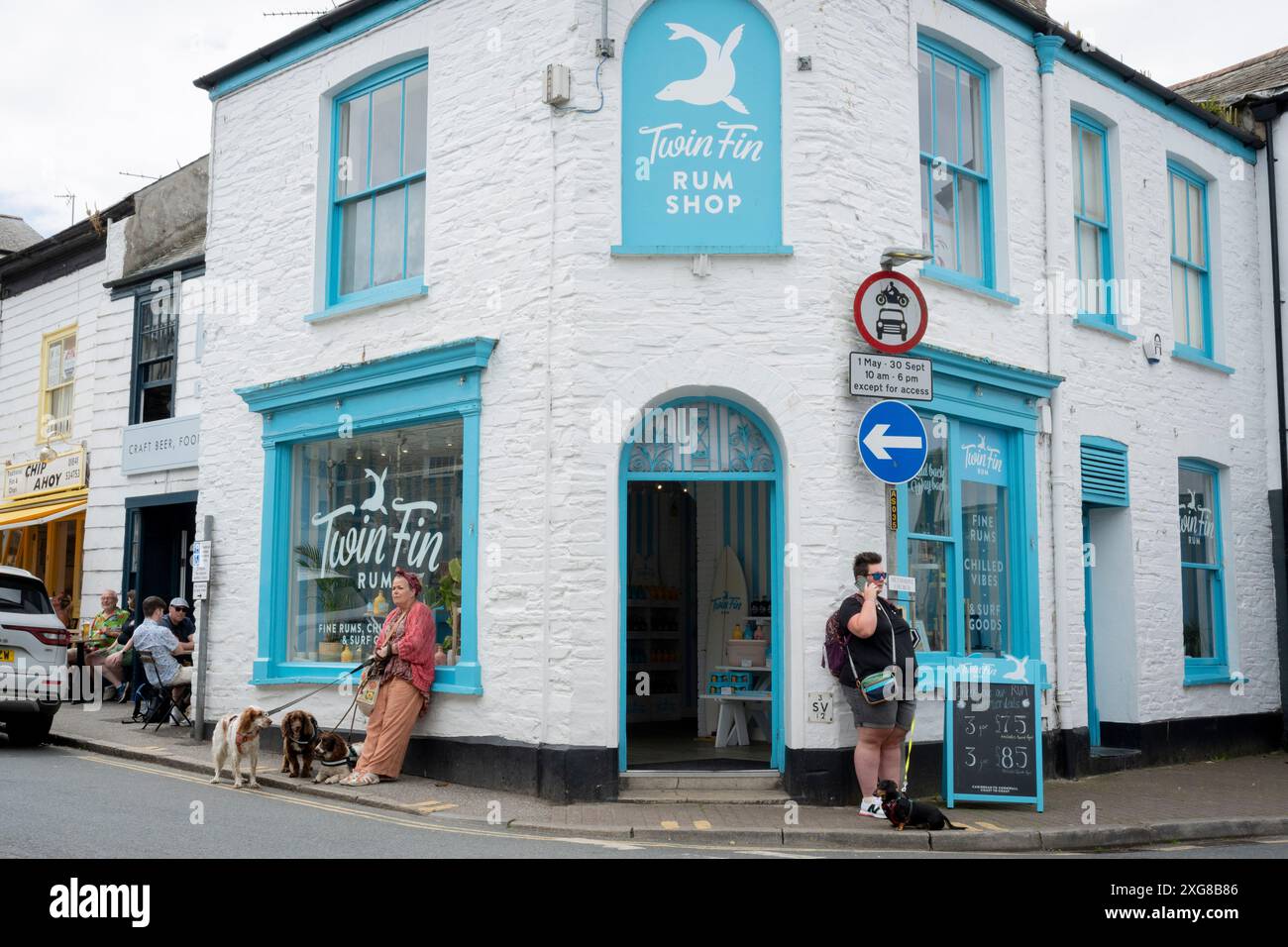 Tourists and pet dogs outside a local retailer in Padstow, on 27th June 2024, in Padstow ...