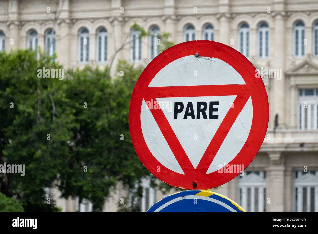 Round traffic sign with word STOP translated to English (PARE in ...