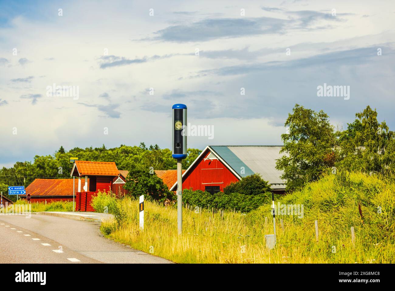 Rural scene featuring winding road with speed camera, surrounded by ...