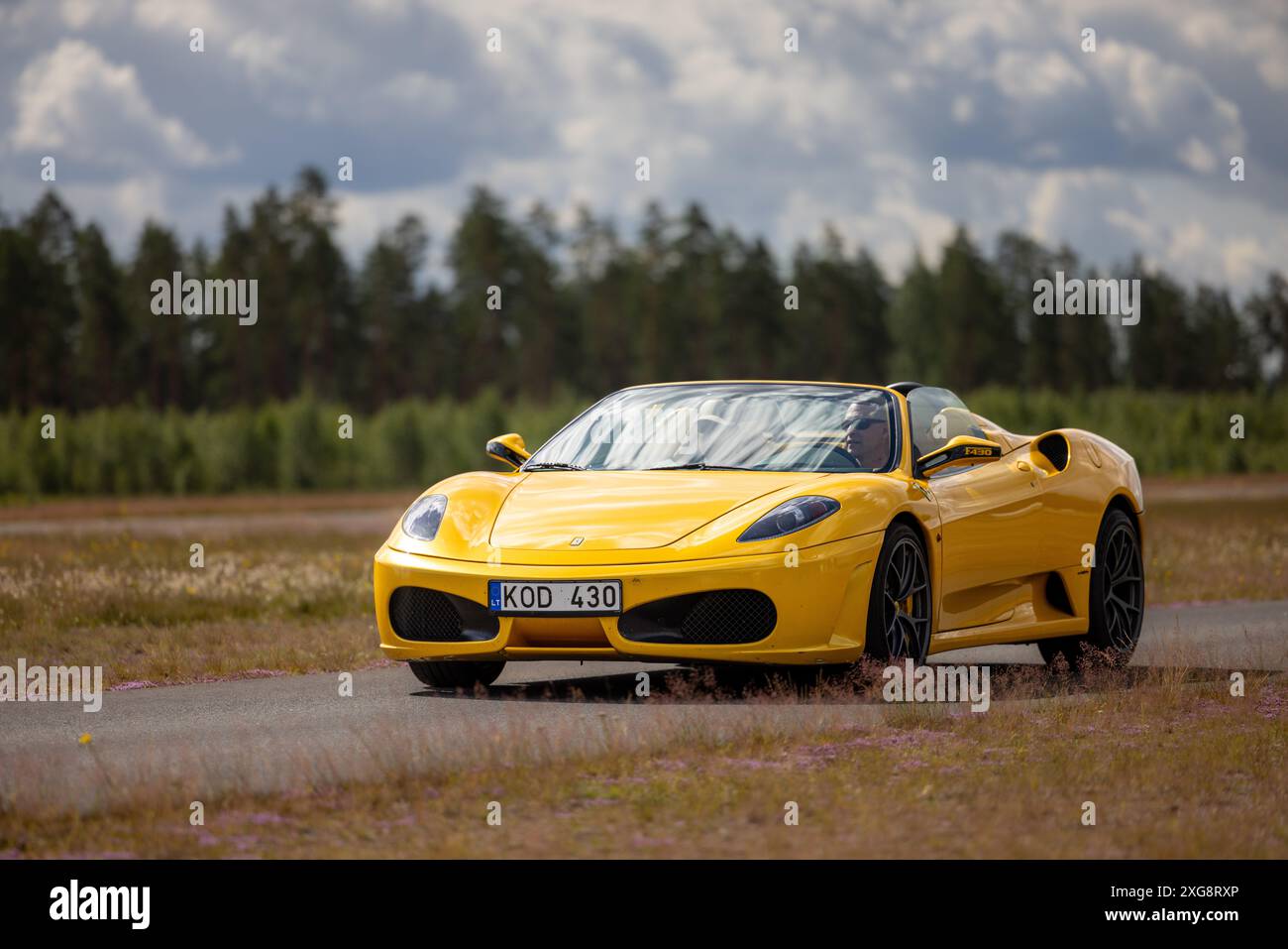 A yellow Ferrari f340 driving on a runway in Southern Finland Stock ...