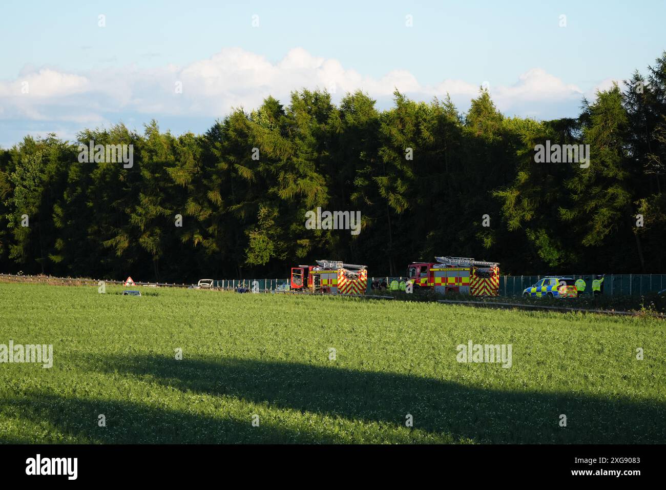 Emergency services by a field by the M9 motorway near Stirling by a car ...