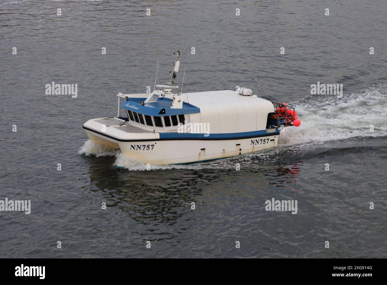 The 10 metre fishing catamaran FV MERIDIAN departing from the harbour ...
