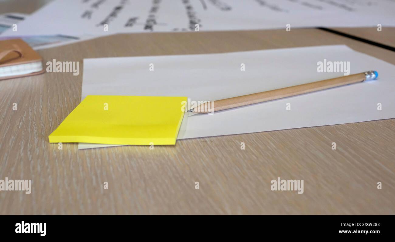 Sticky notes, papers and a pencil during a brainstorming session at a ...