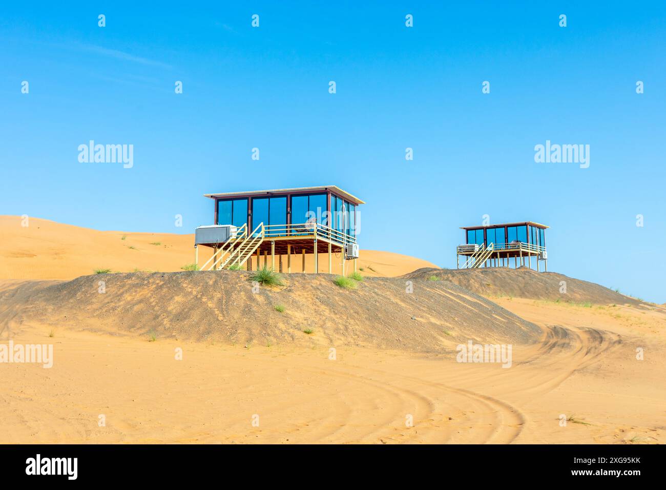 Desert hotel houses standing above the sands in the middle of Wahiba ...