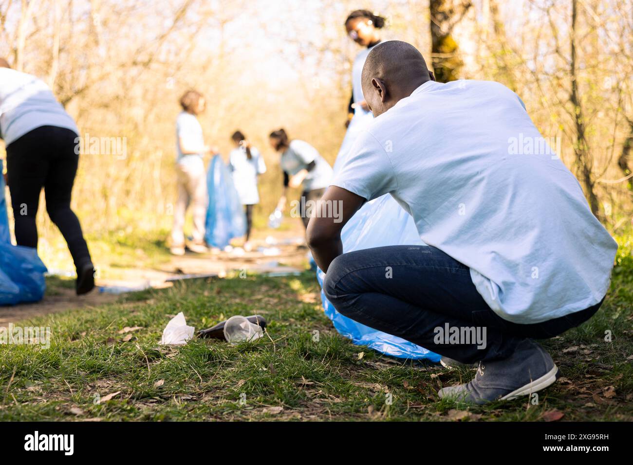 African american activist using disposal bags to recycle trash and ...