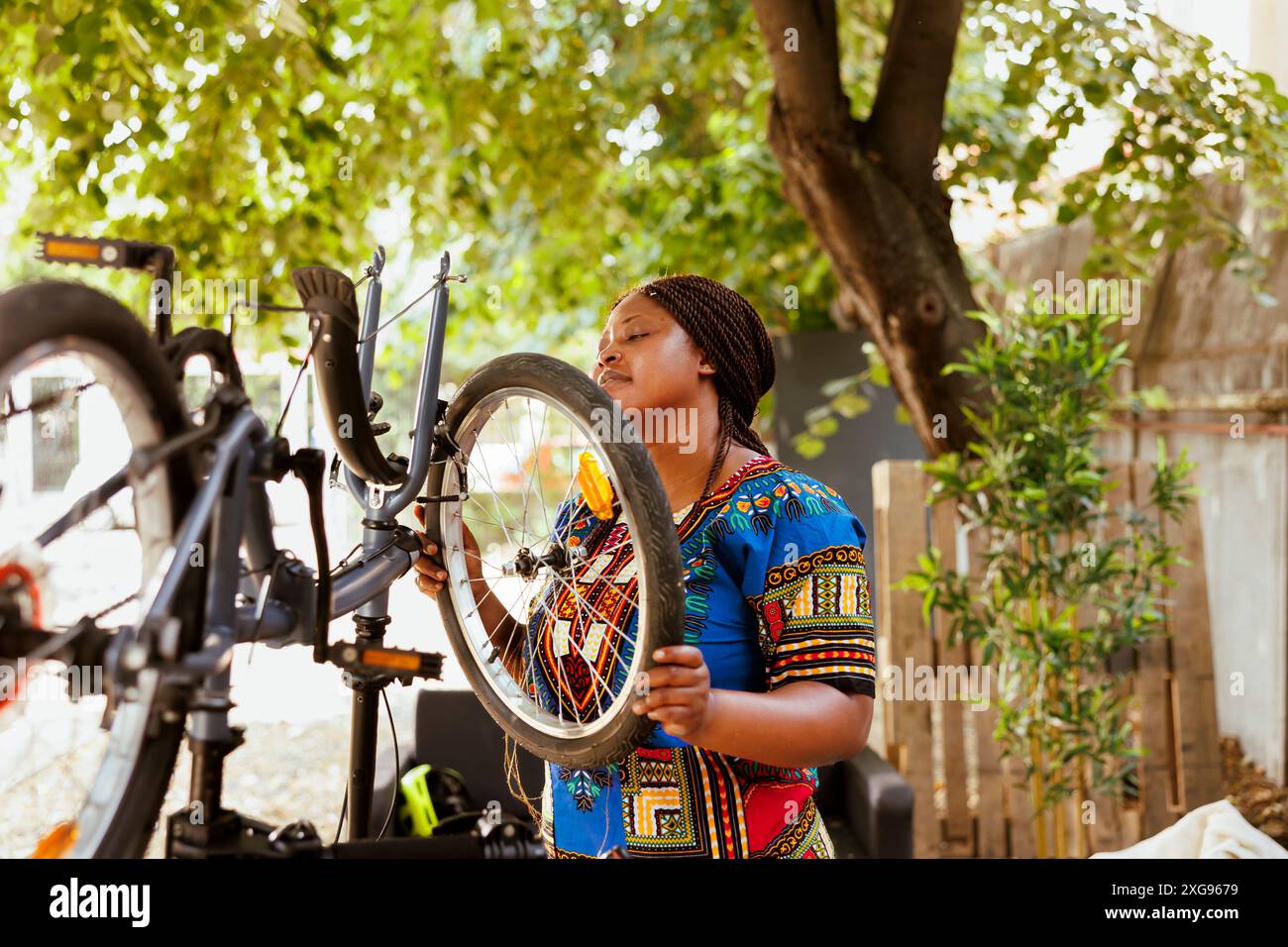 Young athletic african american woman mending modern bicycle ...