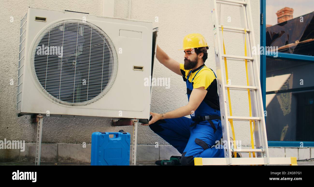 Professional worker starting work on malfunctioning air conditioner ...