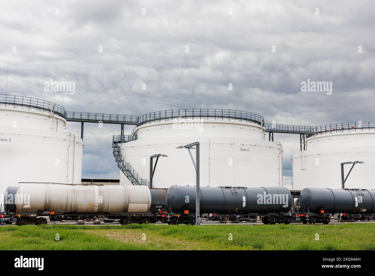 Row many large industrial fuel storage white tanks cloudy overcast sky ...