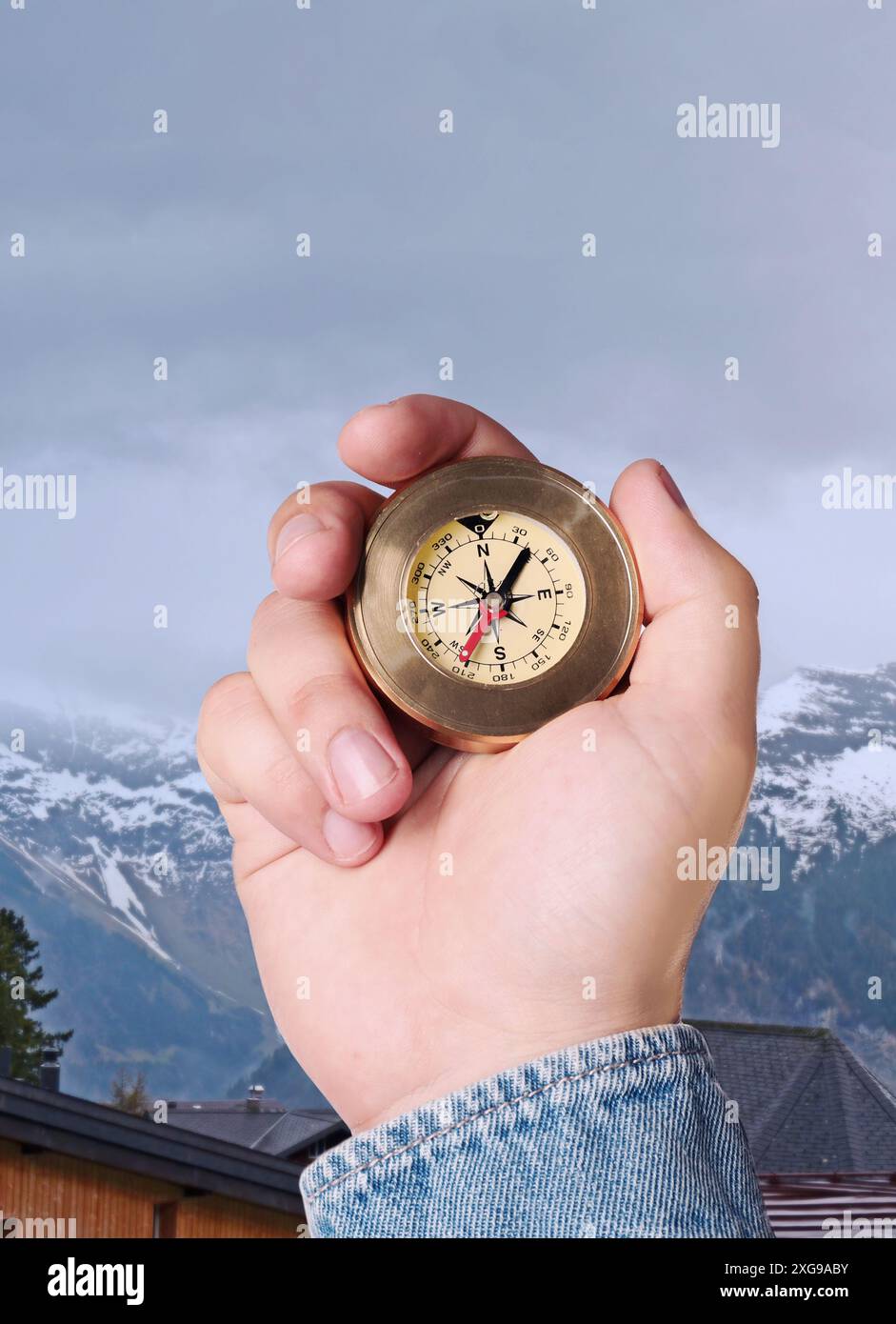 Man using compass in mountains, closeup. Navigational instrument Stock ...