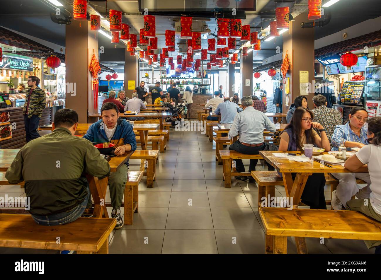 People eating in the Aisan food court on High Street in Staines-upon ...