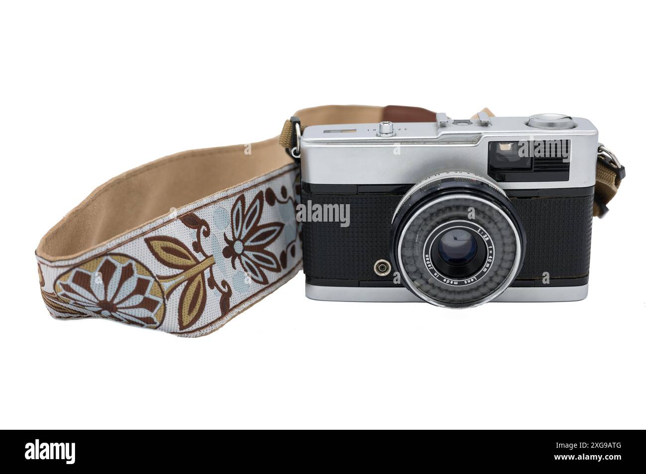 Detail of an old compact photo camera with a nice strap on a white ...