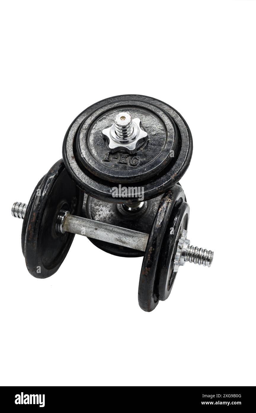 Detail of a screw-on dumbbell kit with metal weight plates on a white ...