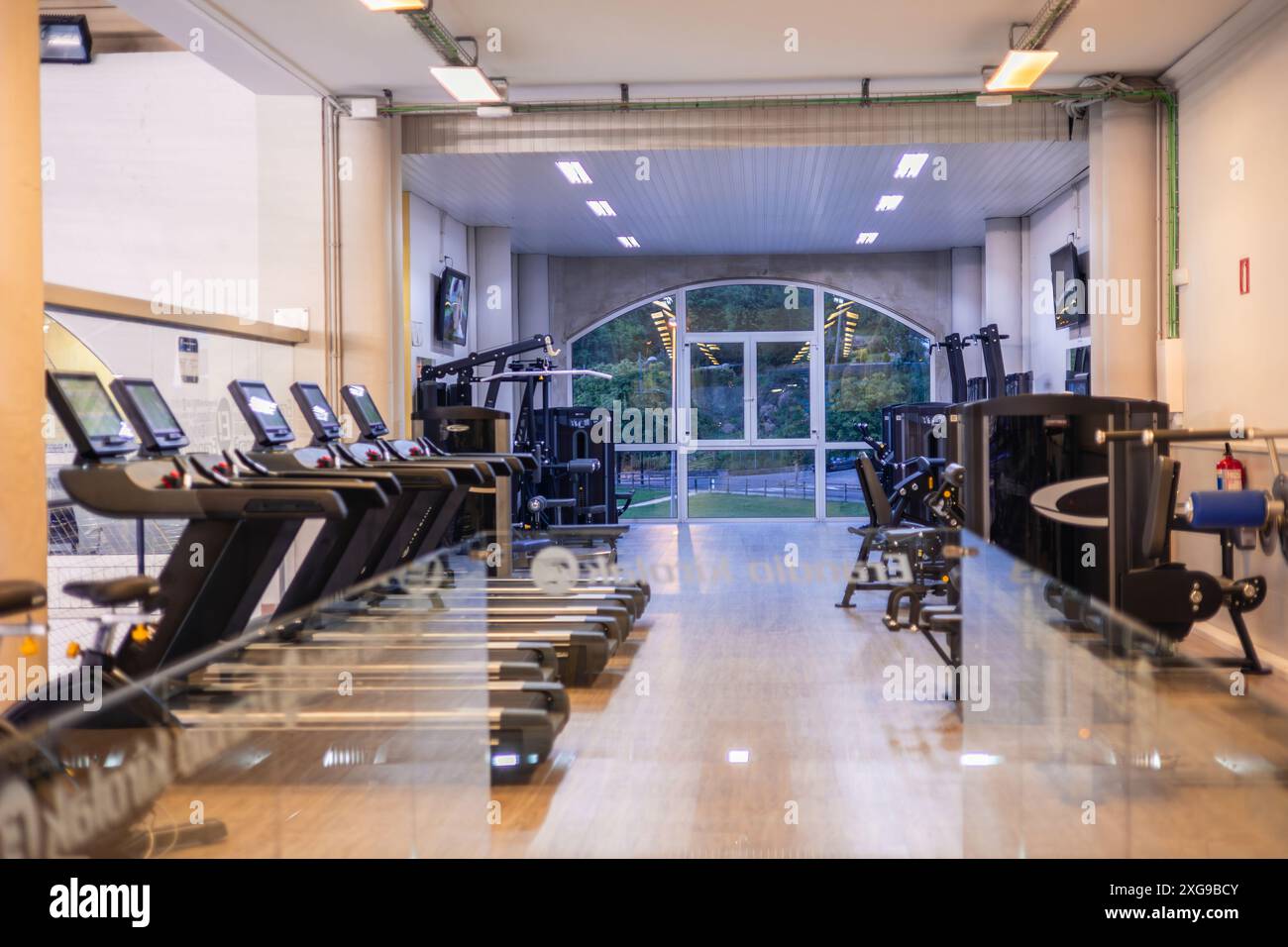 wide-angle view of a gym space featuring various cardio and strength ...