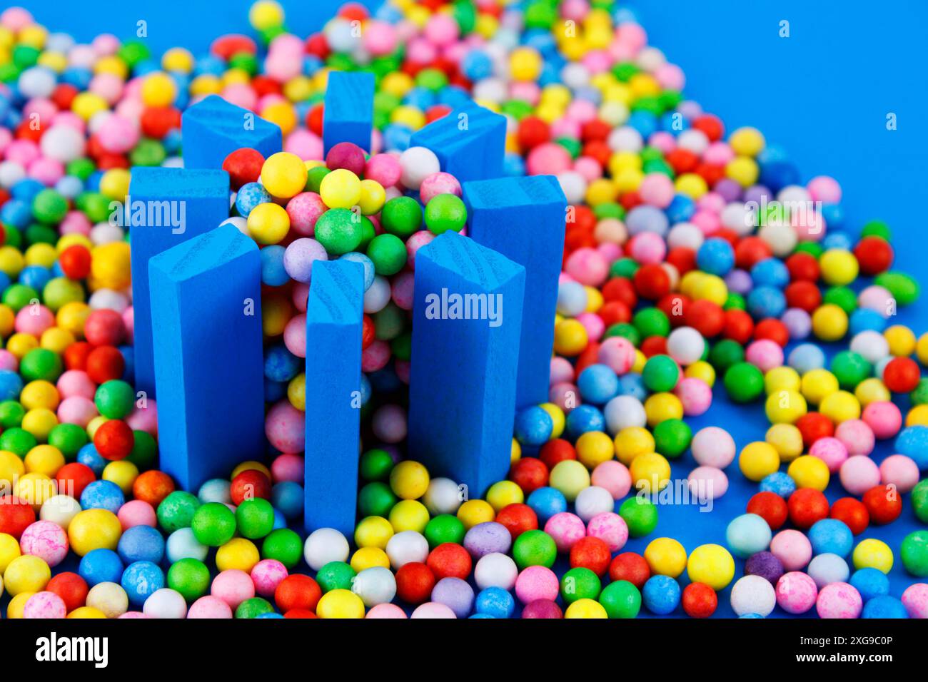 Multiple colorful spheres trapped by structure formed with wooden ...