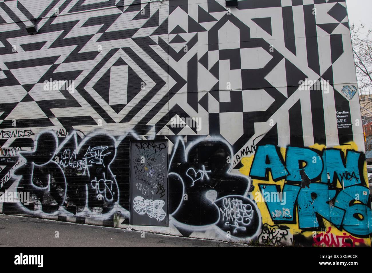 Graffiti tagged on a building in an alley near Saint-Laurent Boulevard ...