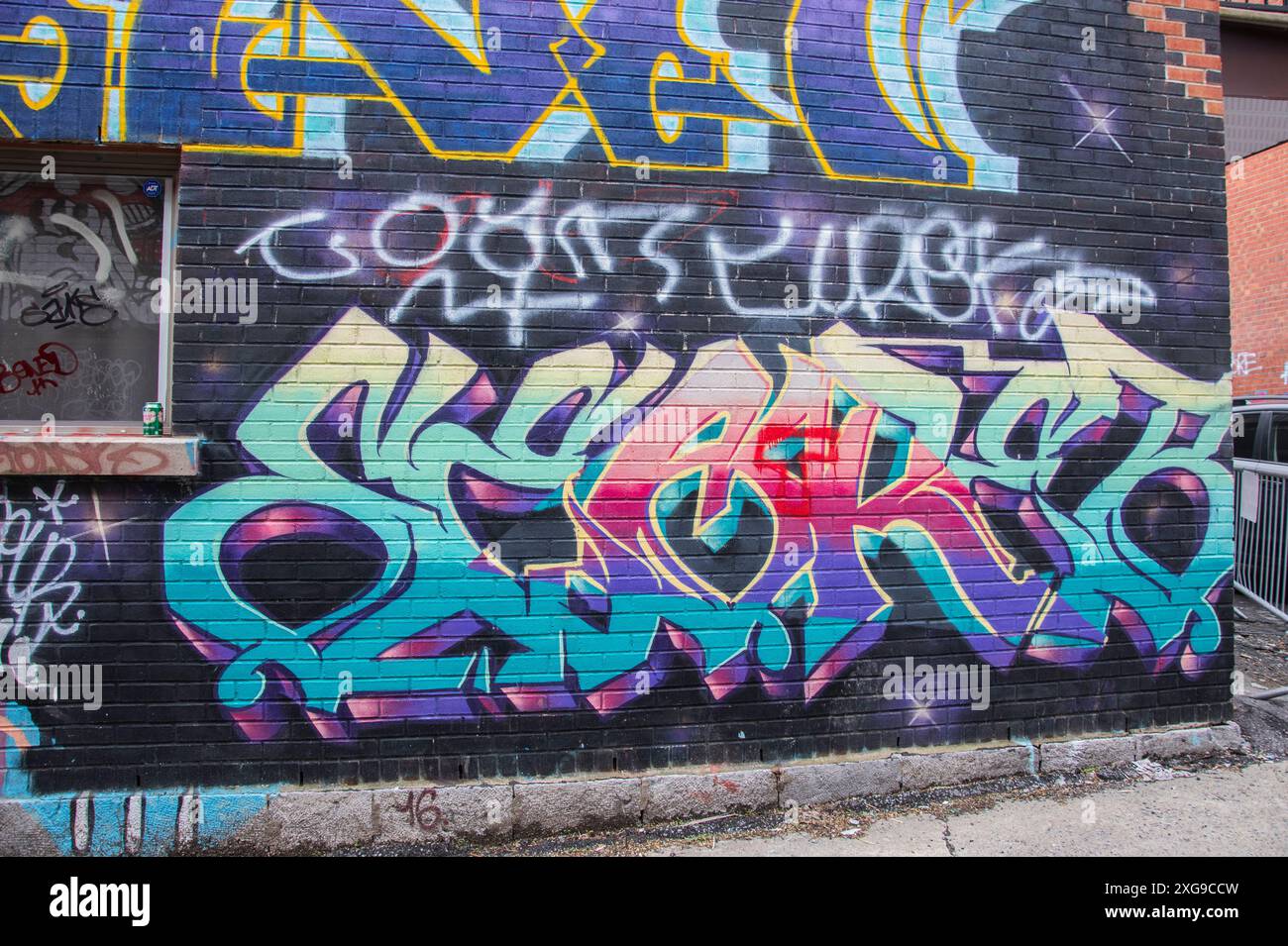 Graffiti tagged on a building in an alley near Saint-Laurent Boulevard ...