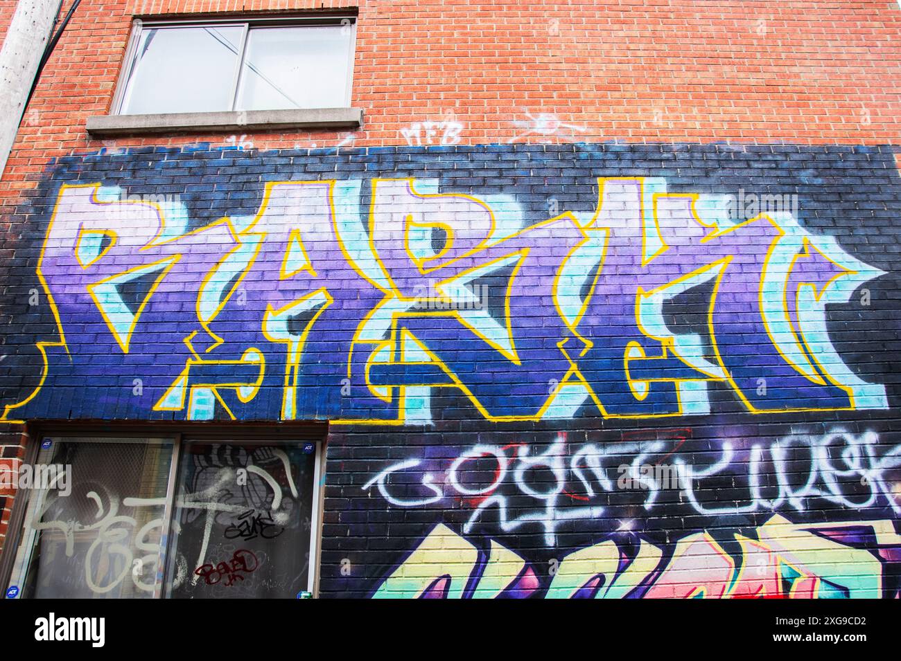 Graffiti tagged on a building in an alley near Saint-Laurent Boulevard ...