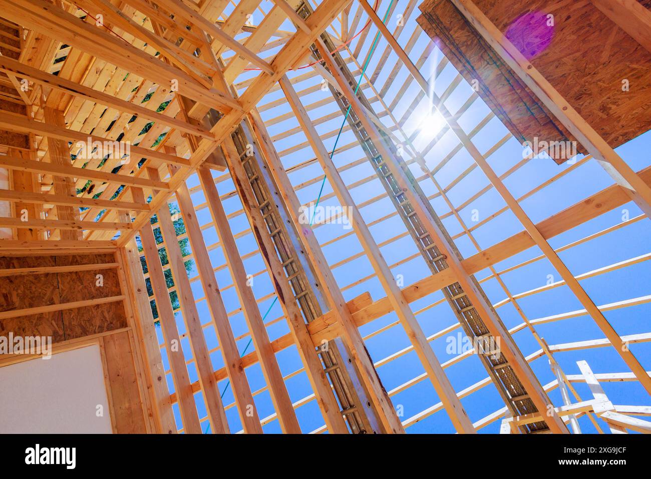 Roof of new timber truss framed home is in process of being installed ...