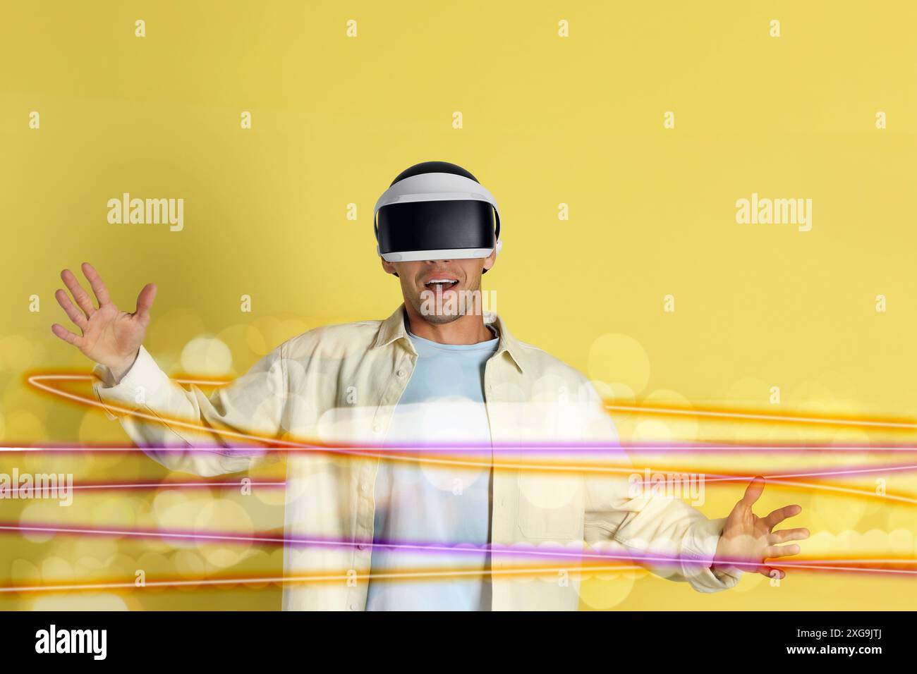 Man using virtual reality headset on yellow background. Modern ...