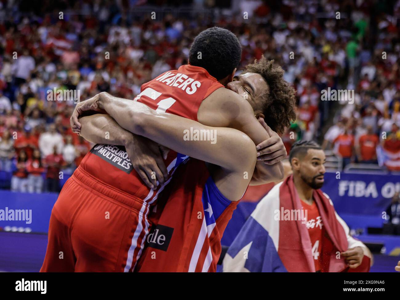 Puerto Rico's George Conditt IV, center, and Arnaldo Toro, embrace ...
