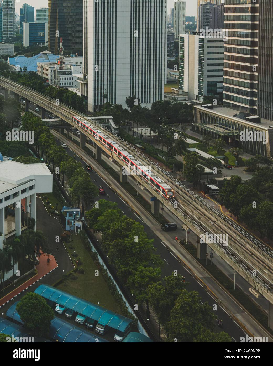 Jakarta, Indonesia - May 12th, 2024. a city in constant motion. A red train streaks through the ...