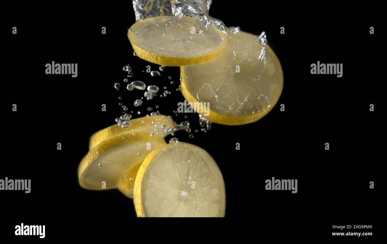 Lemons, falling into water. Isolated background Stock Photo - Alamy