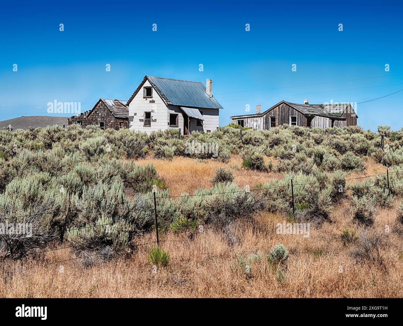 An old homestead ranch with a house, barn and other abandoned buildings ...