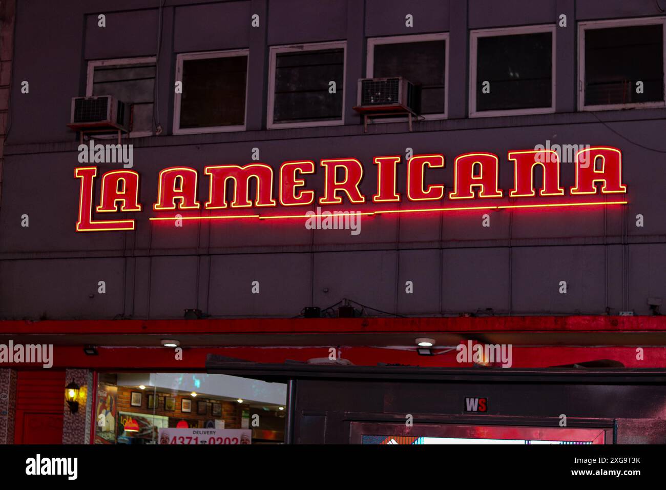 neon sign of the La Americana pizza restaurant on Avenida Corrientes ...